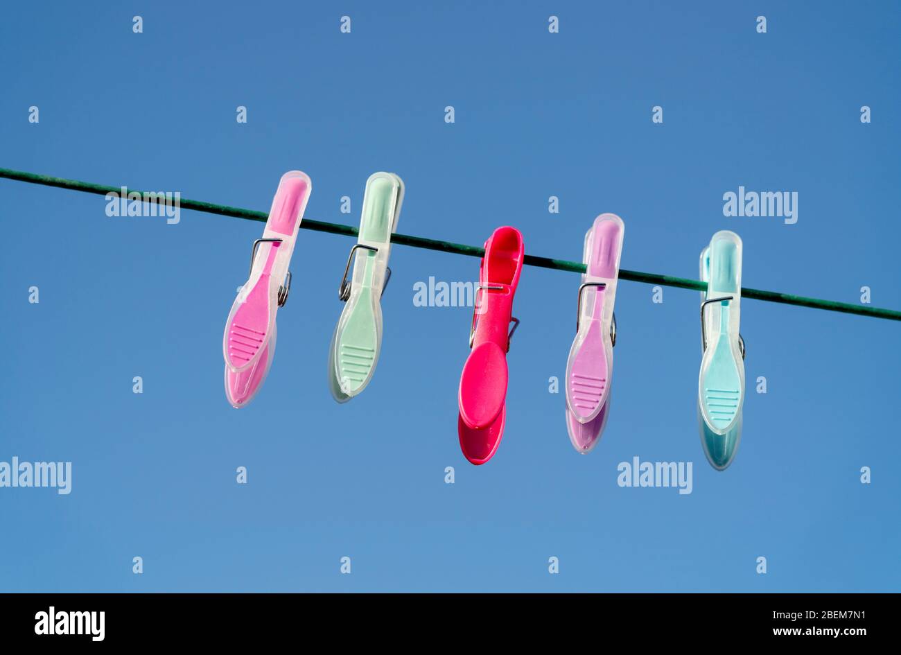 Colourful plastic clothes pegs hanging on a washing line Stock Photo ...