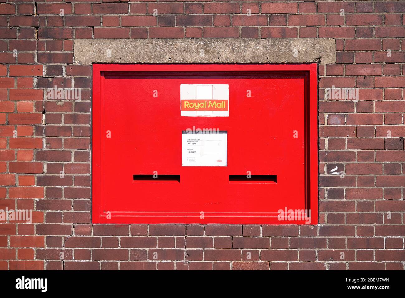 Bright red painted Royal Mail letter box set in brick wall Stock Photo ...