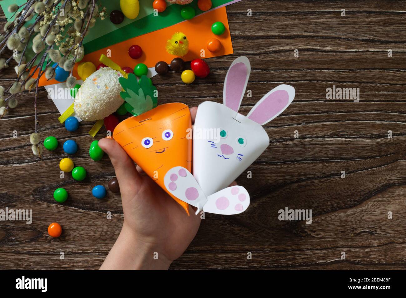 Child holds the packaging in the form of carrots and the Easter Bunny ...