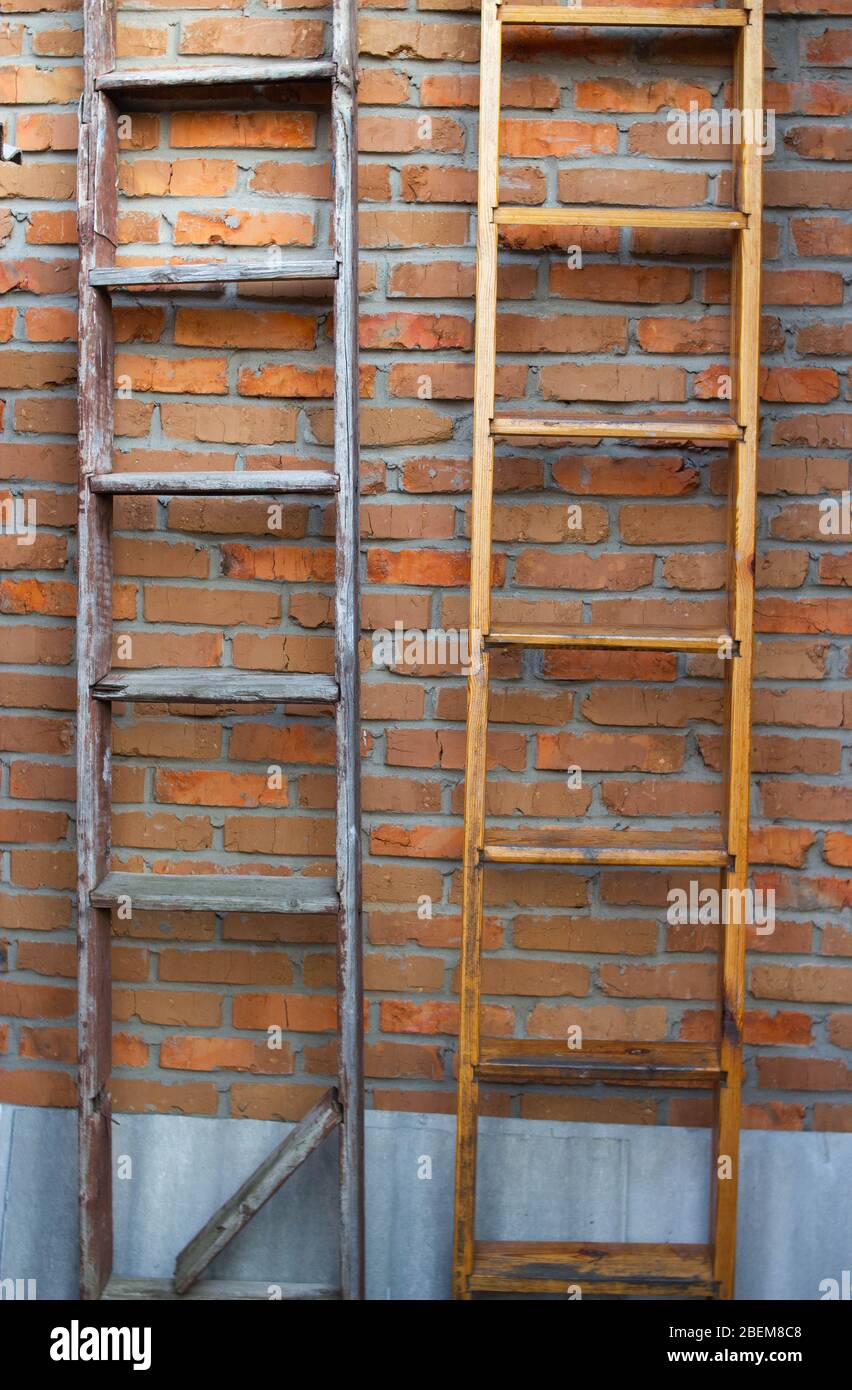 Simple wooden ladder at the rough brick wall Stock Photo - Alamy