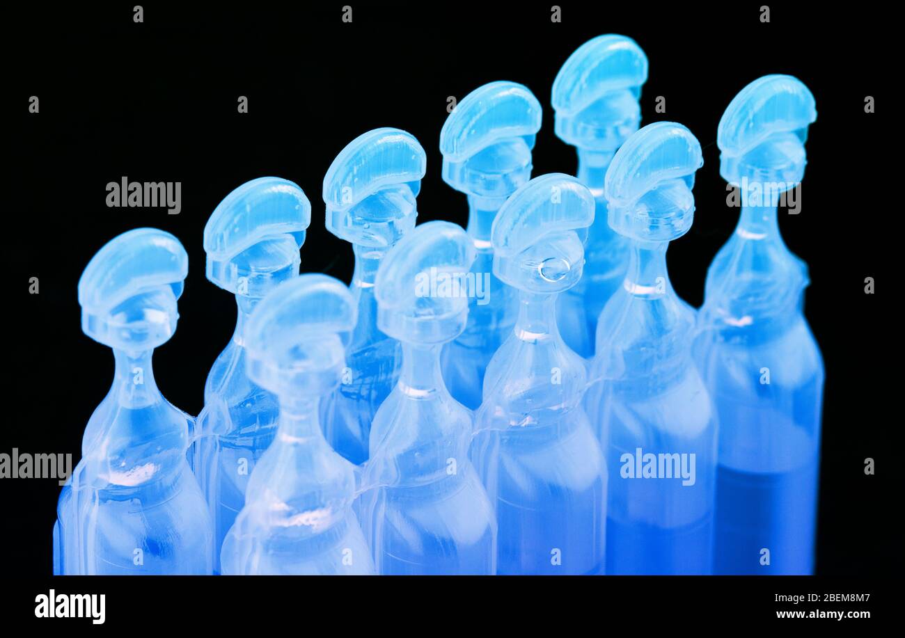 horizontal perspective view of many blue plastic medical sterile water ...