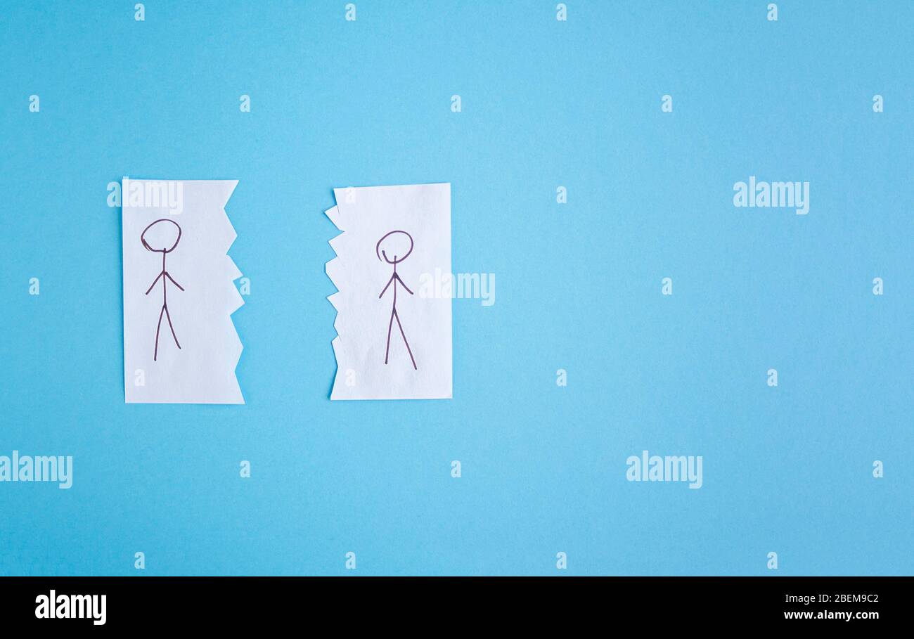 Two people drawn on pieces of paper lie next to each other. The concept ...