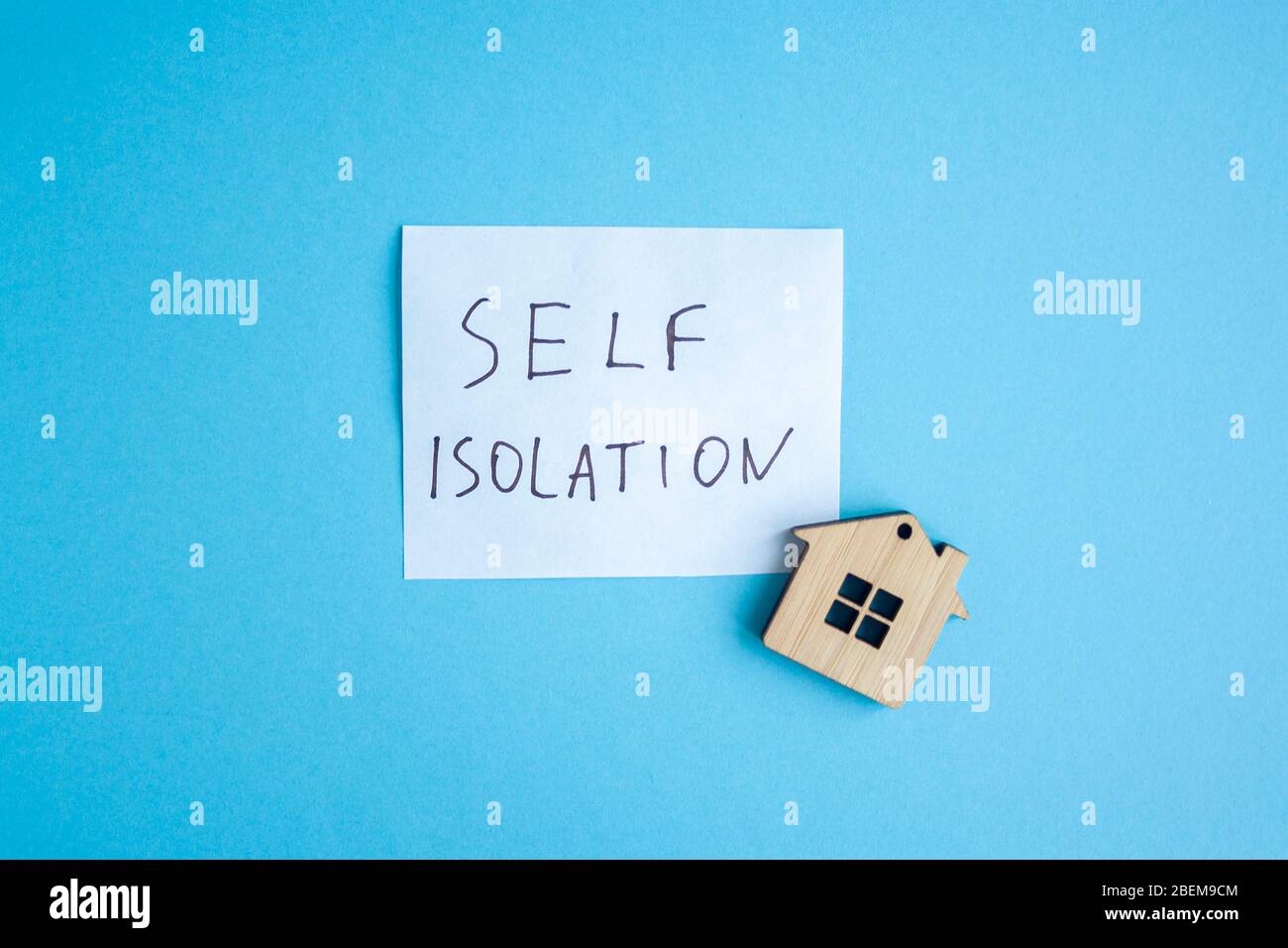 The inscription on a white sheet quote self isolation with small wooden ...
