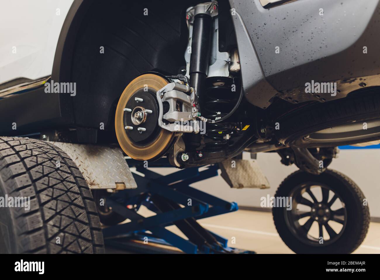 modern car service. back view of car in room service. Wheel replacement ...