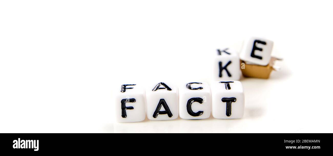 fake and fact text formed of white dices with black letters on white ...