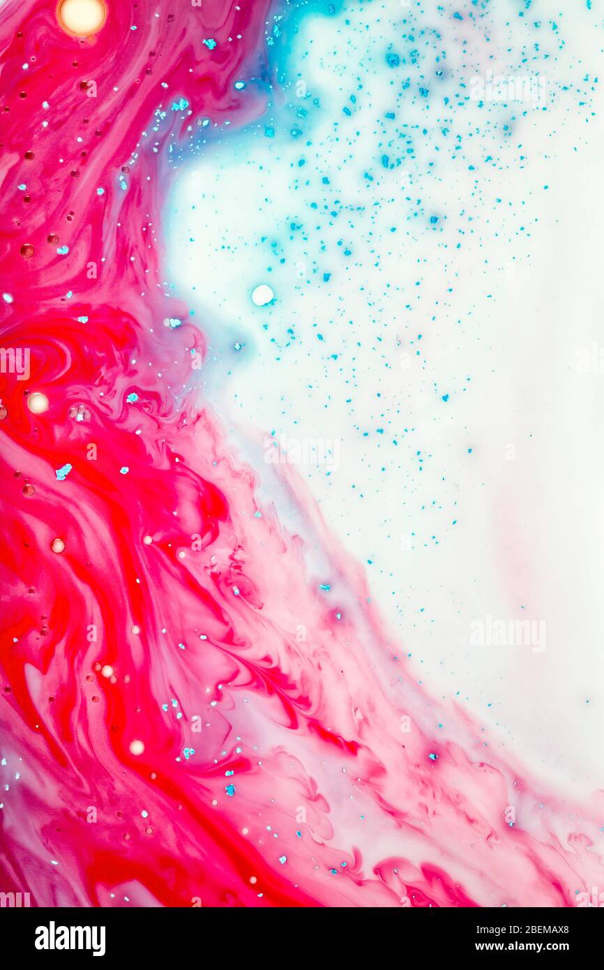 Macrophotograph of red and blue ink settling down in liquid Stock Photo ...
