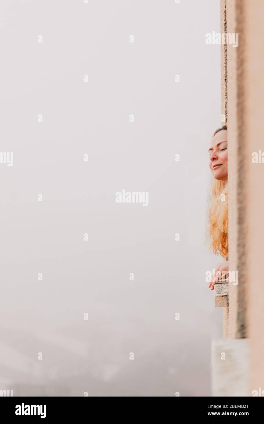 Woman bending over the window watching outside and breathing Stock ...