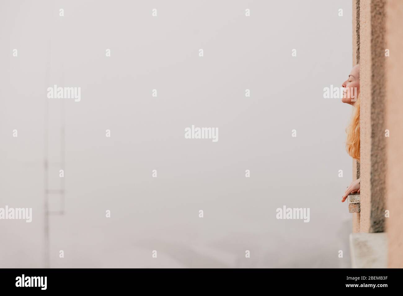 Woman bending over the window watching outside and breathing Stock ...