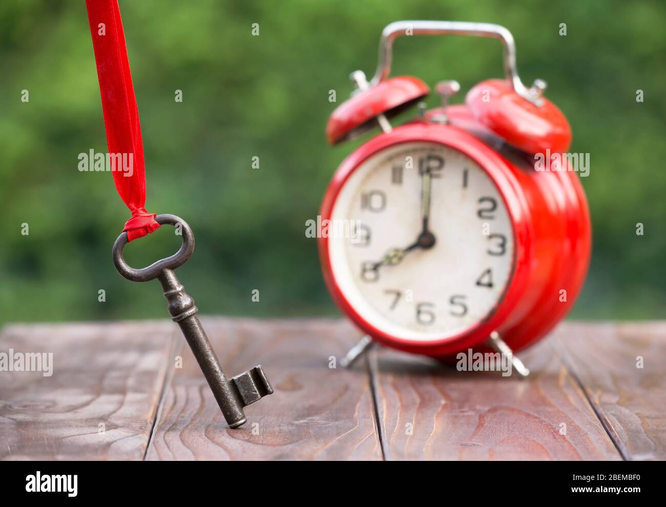Time management concept, key and classic red alarm clock Stock Photo ...