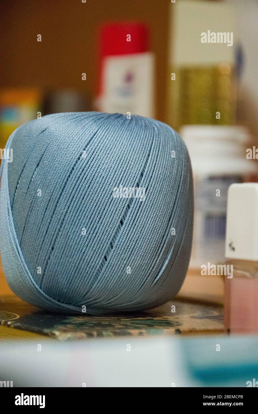 Ball of thread on a table with blurred surroundings, cluttered Stock ...