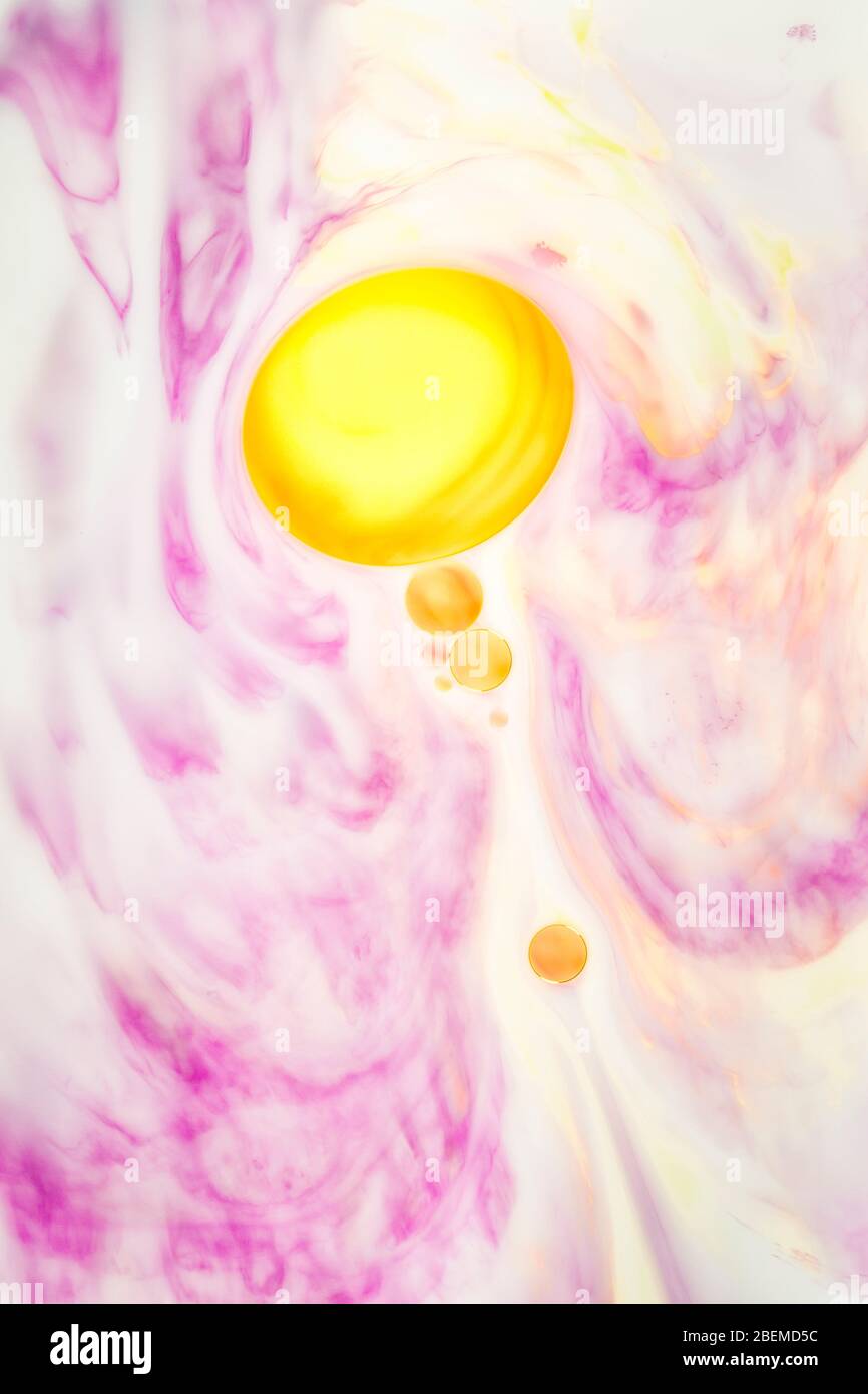 Flowing yellow bubble in pink ink Stock Photo - Alamy