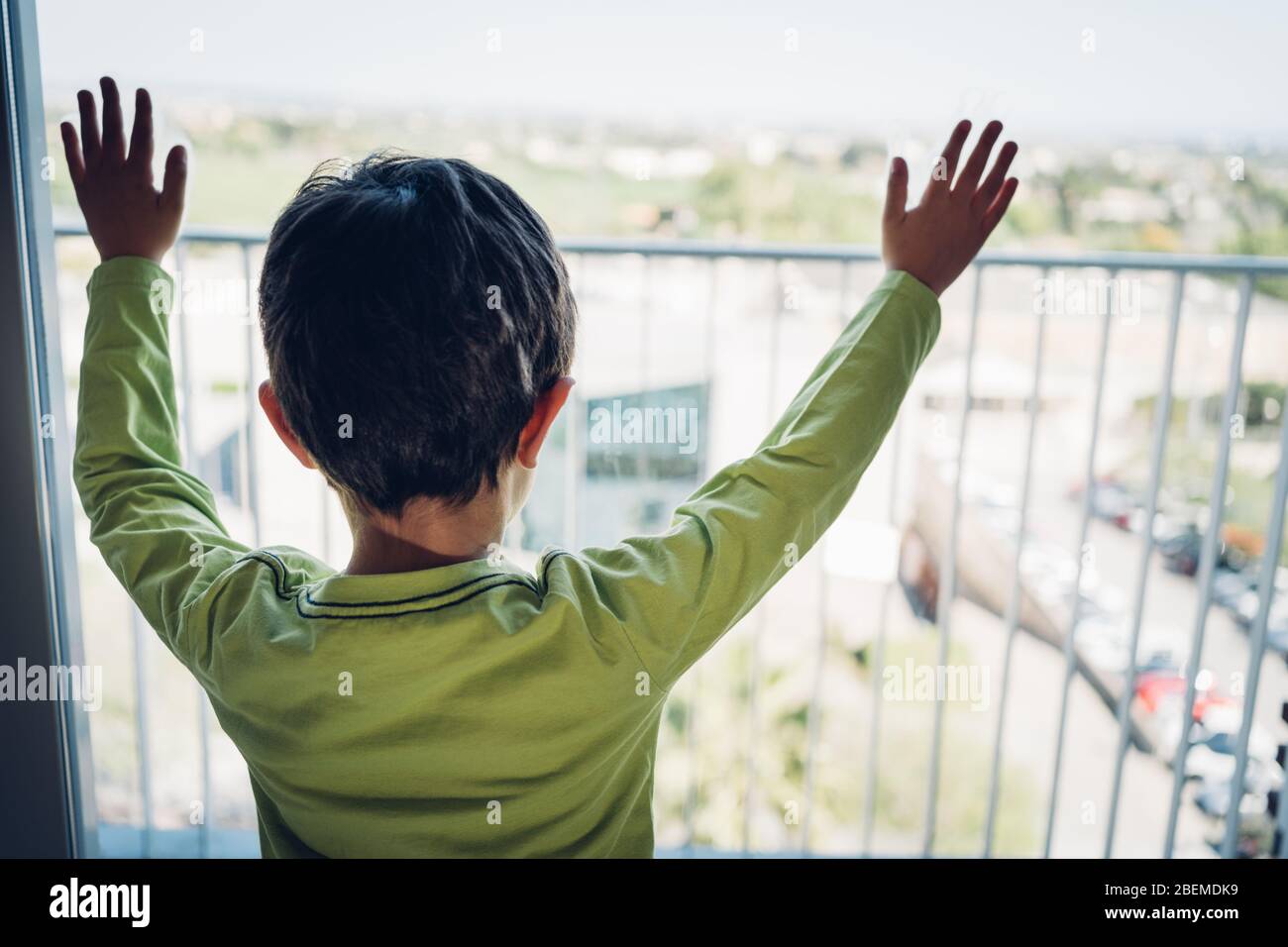 Child looking outside through the window with hope Stock Photo - Alamy