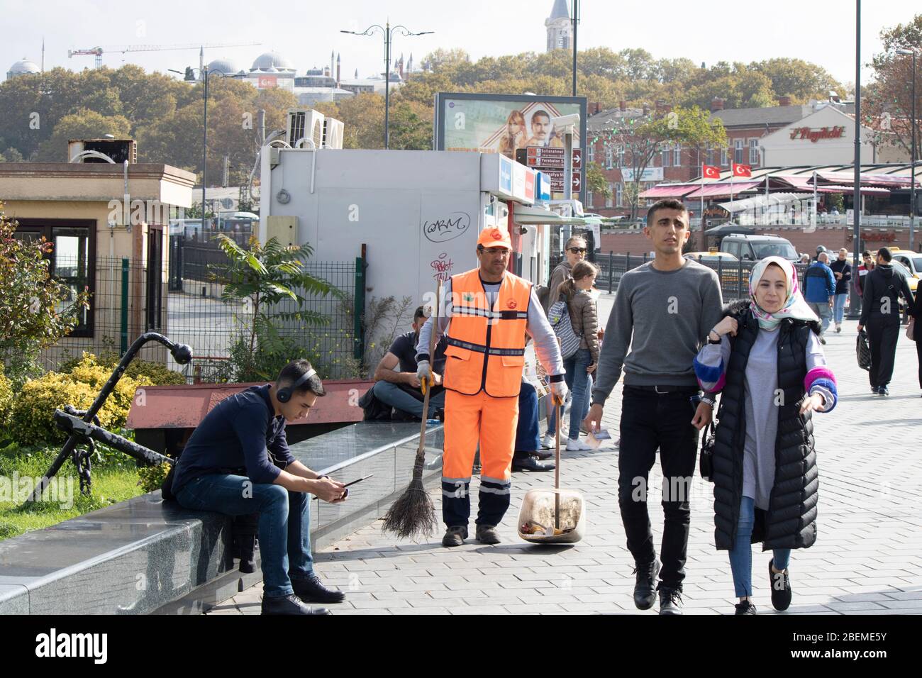 Traffic lights and people crossing the pedestrian path. A municipal ...