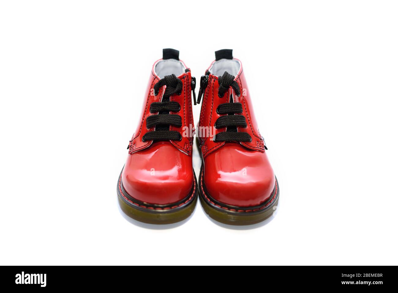 Children's beautiful shiny red boots isolated on the white background ...