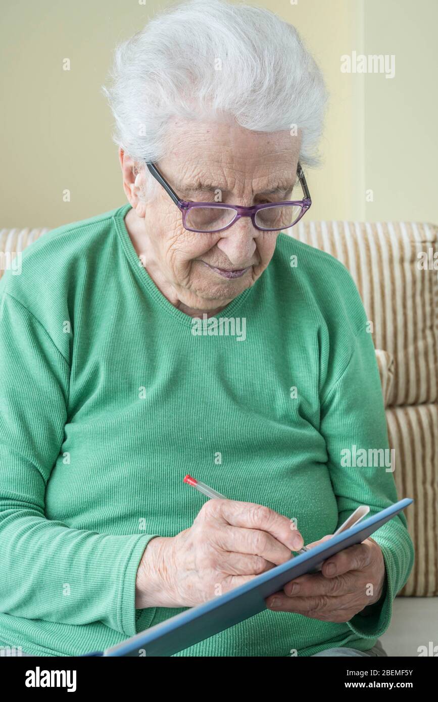Mature woman drawing pencil home hi-res stock photography and images ...