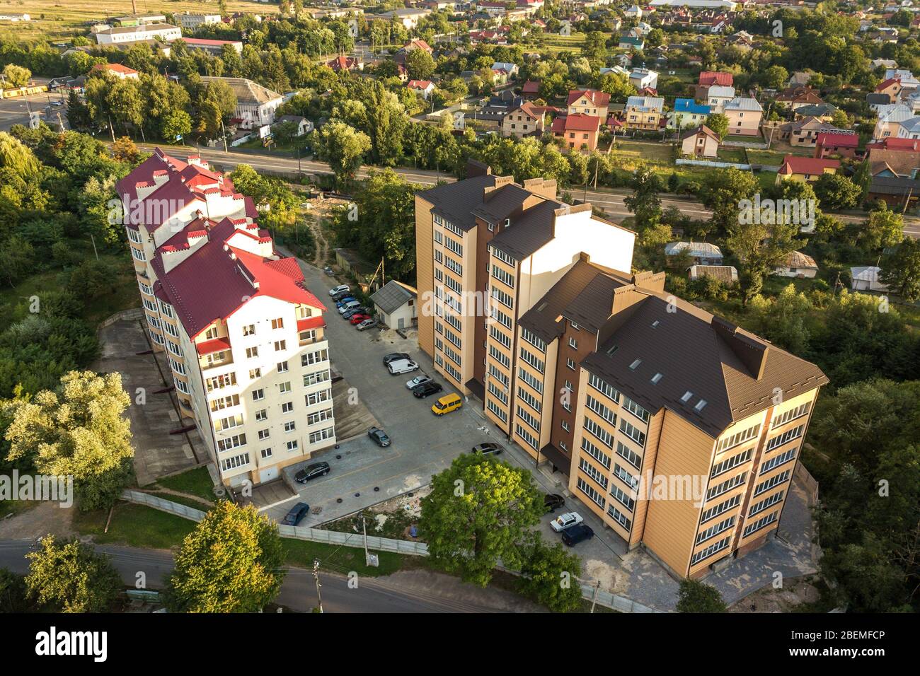 Aerial view of multistory apartment buildings in green residential area ...