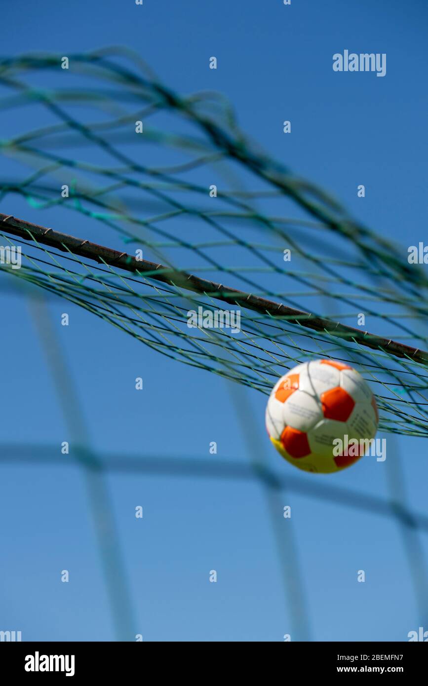 Football hitting the back of a goal net Stock Photo - Alamy