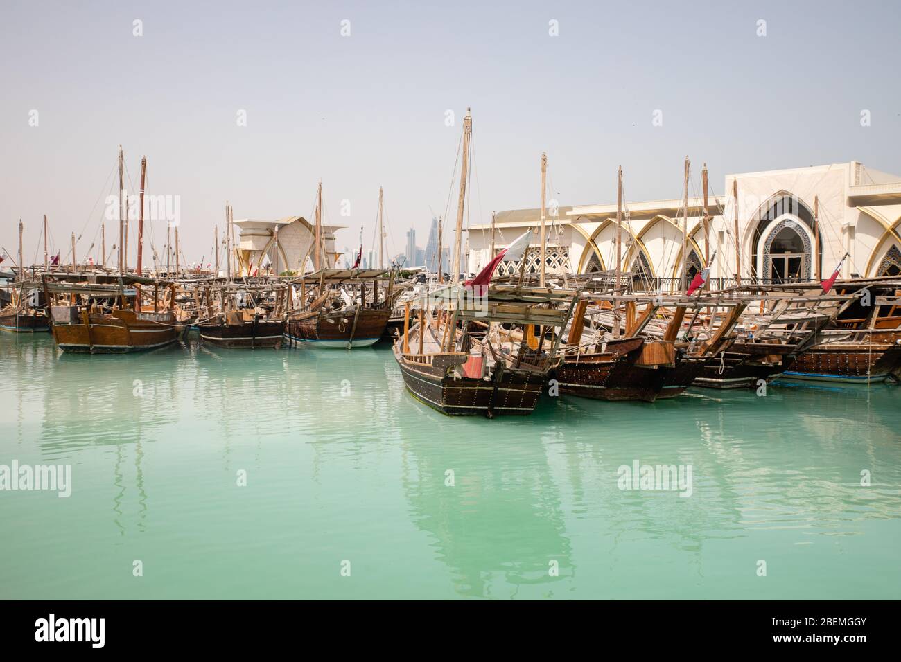 View on wooden ships and Dhow Harbour building in Doha City, Qatar ...