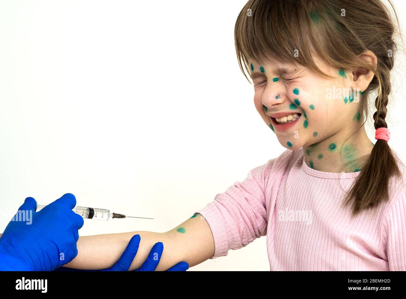 Doctor making vaccination injection to an afraid child girl sick with ...