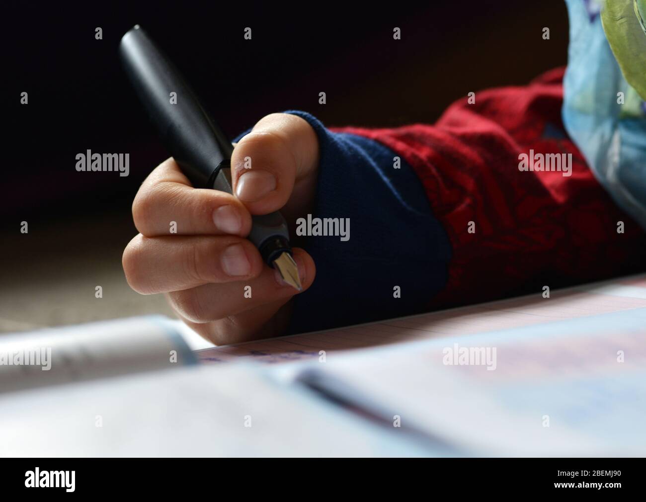 Writing home work with an ink pencil Stock Photo - Alamy