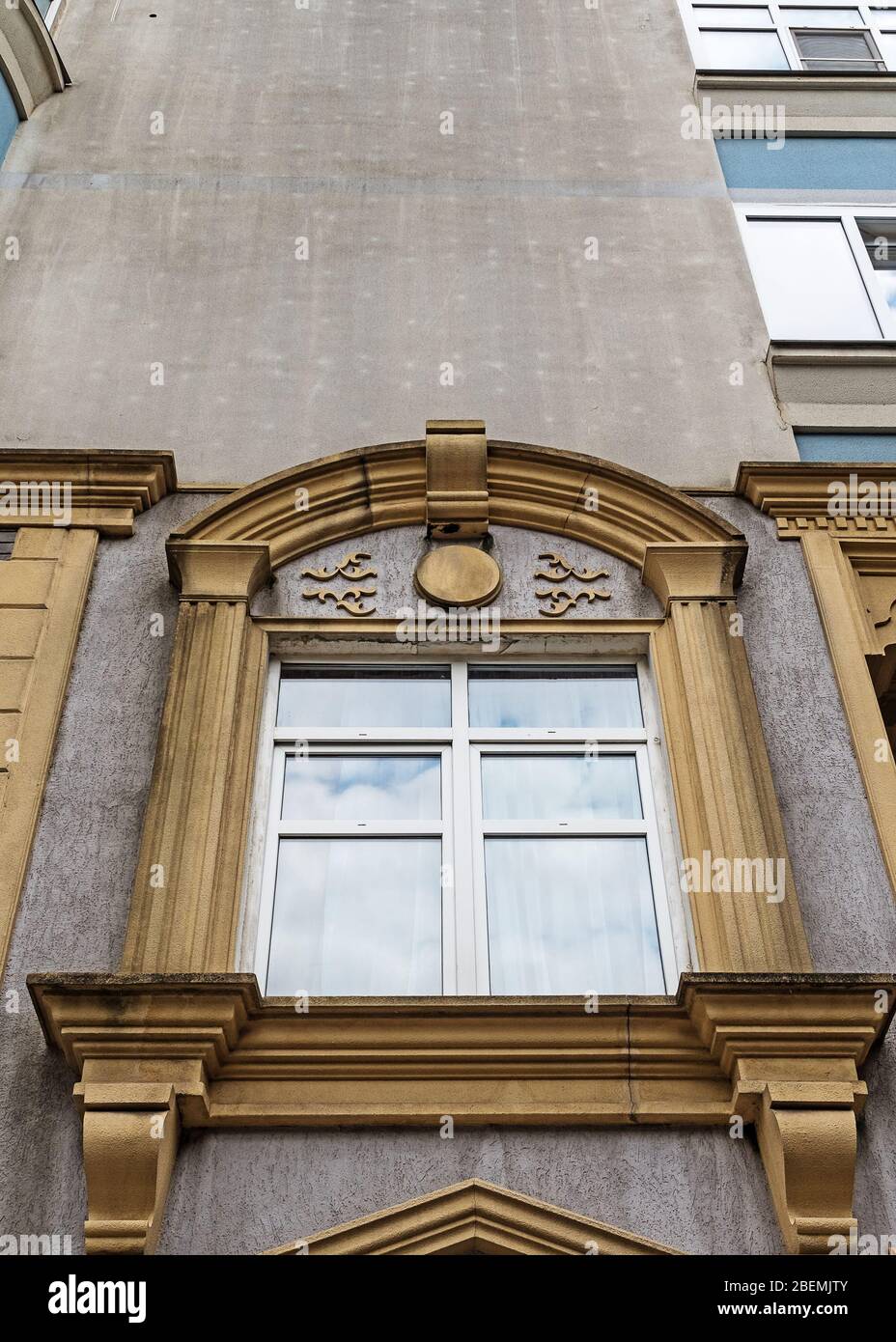 A modern window with decorative elements on the grey facade of the ...