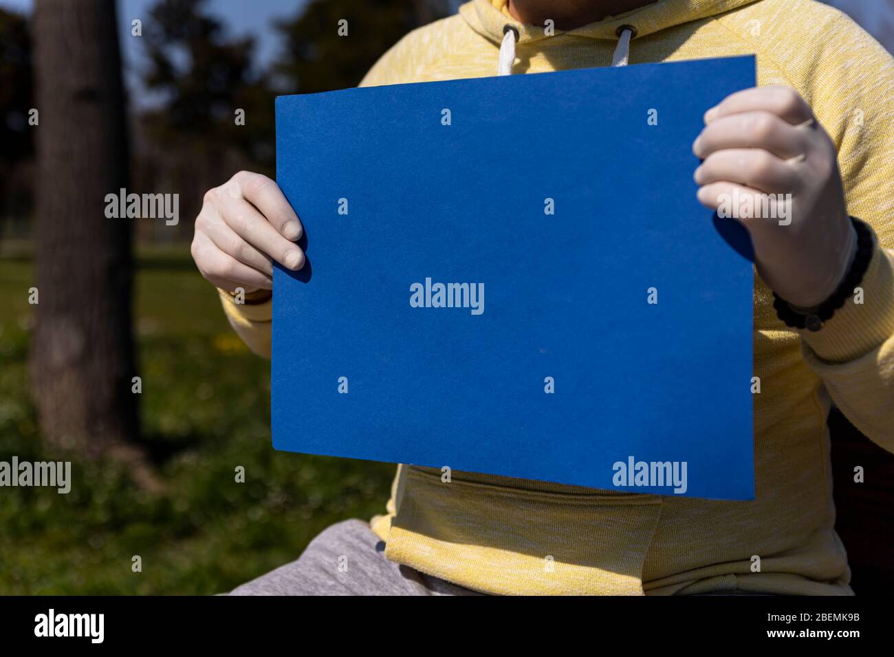 Blue chroma key paper held by a man in surgical gloves Stock Photo - Alamy