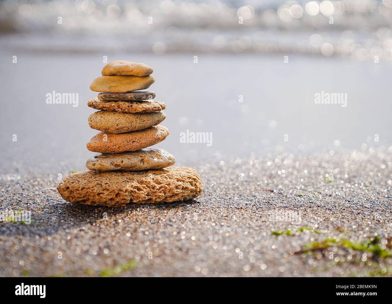Stones pyramid on sand symbolizing zen, harmony, balance. Positive ...
