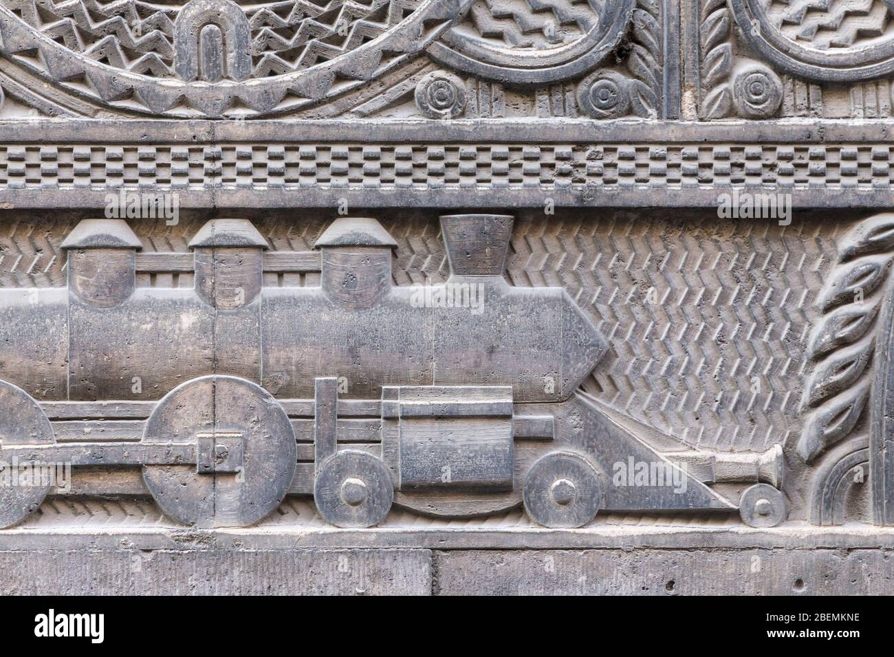 Relief sculpture of a steam train on a wall in Budapest Stock Photo - Alamy