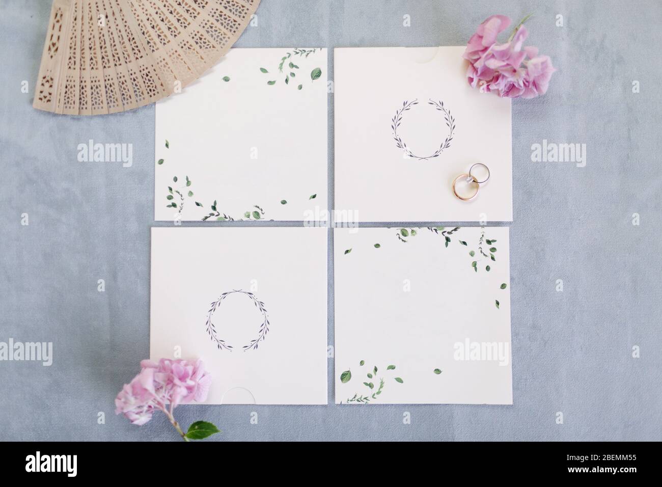 Wedding invitation. Empty white floor. Wedding rings. Fan and purple ...