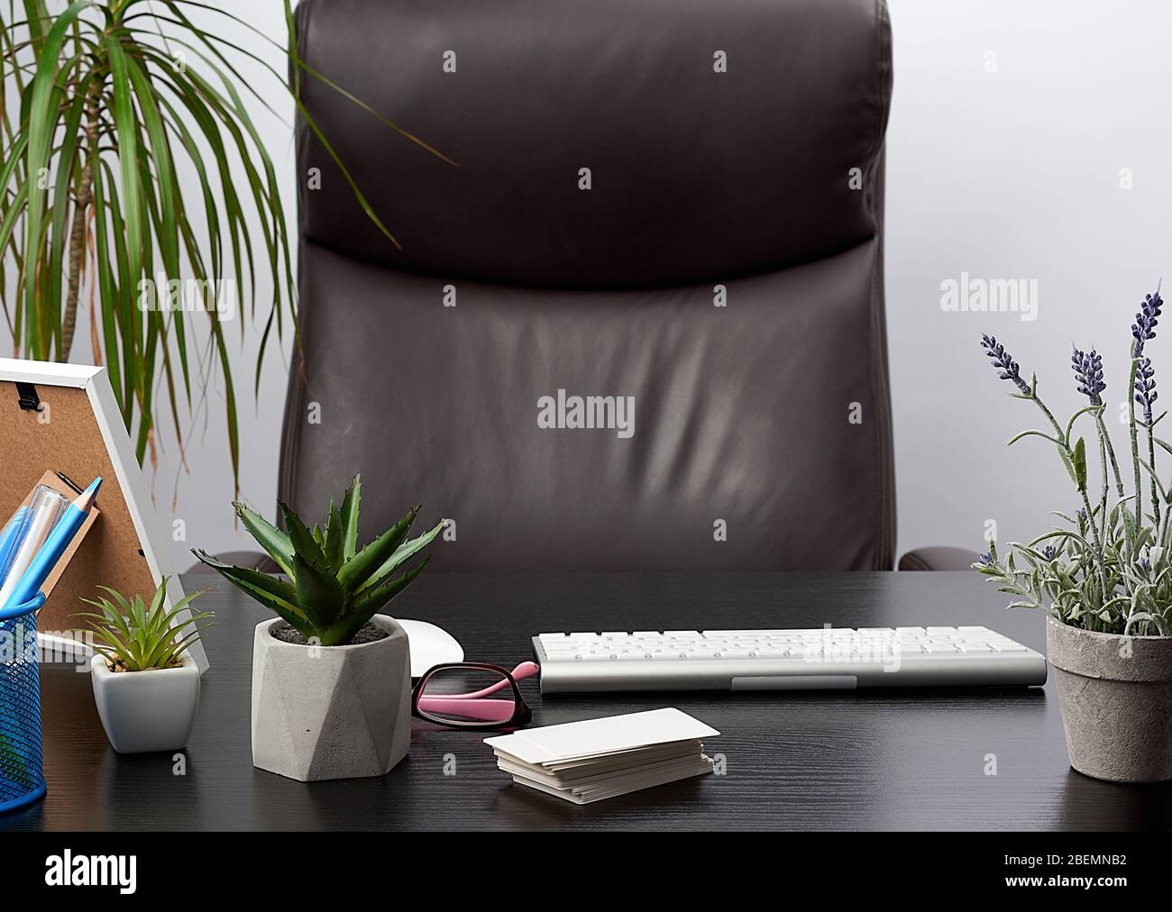 black table with stationery, wireless keyboard, mouse, workplace of a ...
