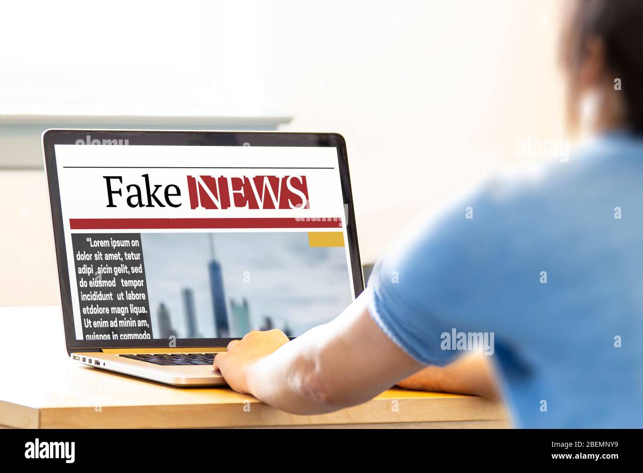 A female reading fake news on a computer laptop Stock Photo - Alamy