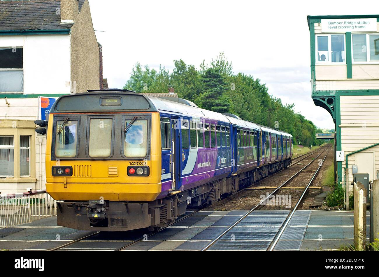 Northern rail Pacer train travels over the level crossing at Bamber ...