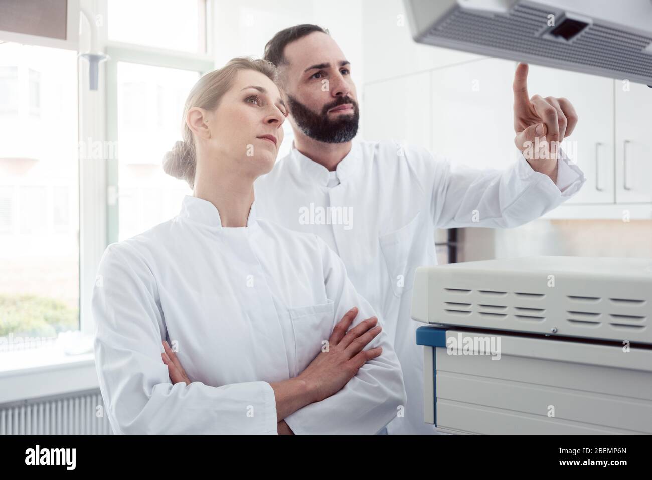 Two doctors looking at a screen with patient data Stock Photo - Alamy