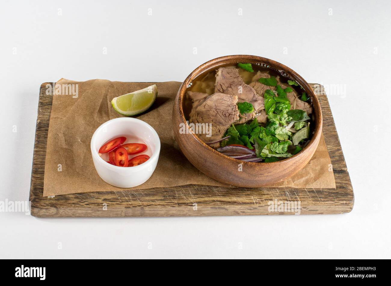 Traditional Vietnamese soup Pho bo with herbs, beef, rice noodles ...