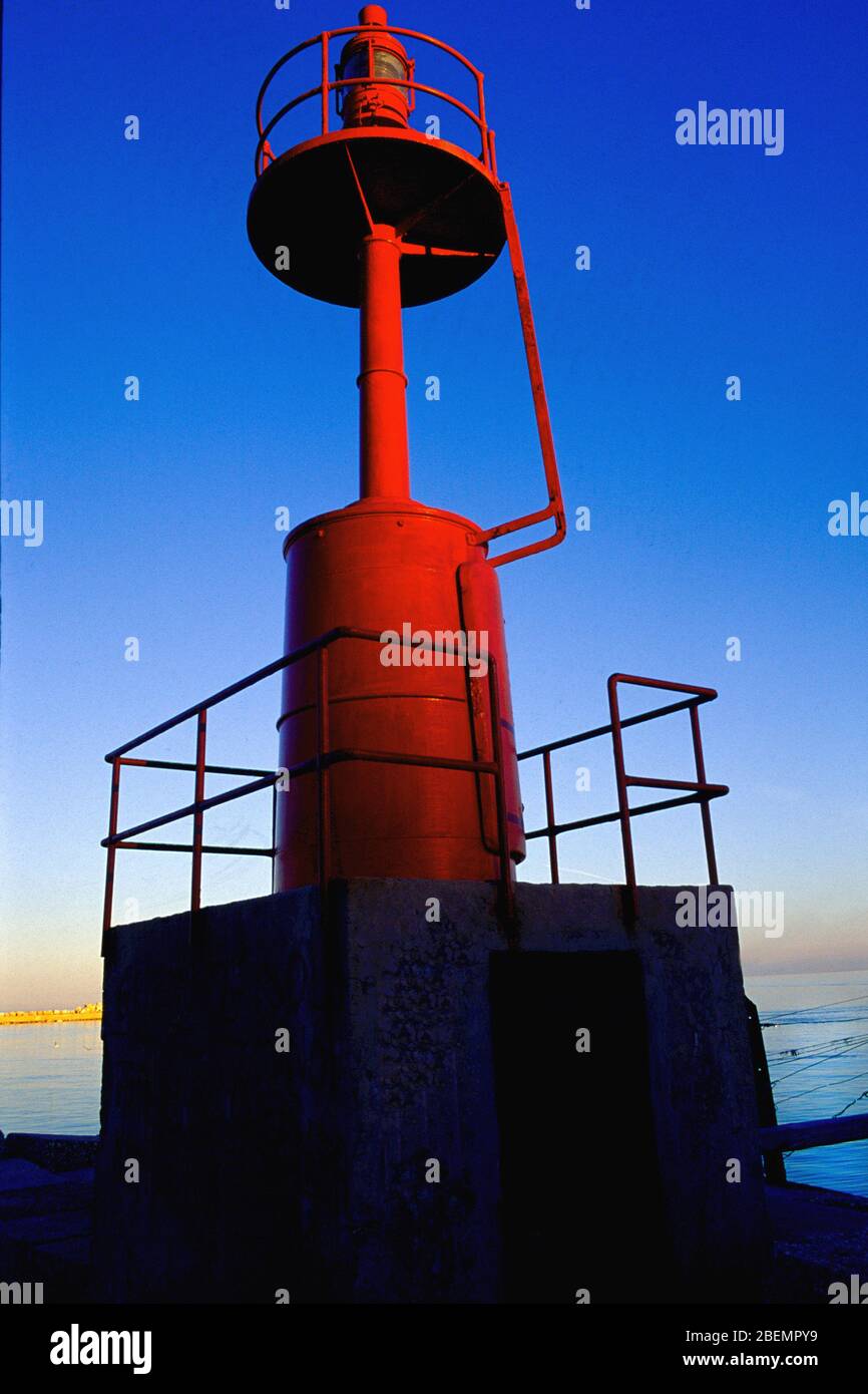 Small red lighthouse at the entrance to a port of Mediterranean ...