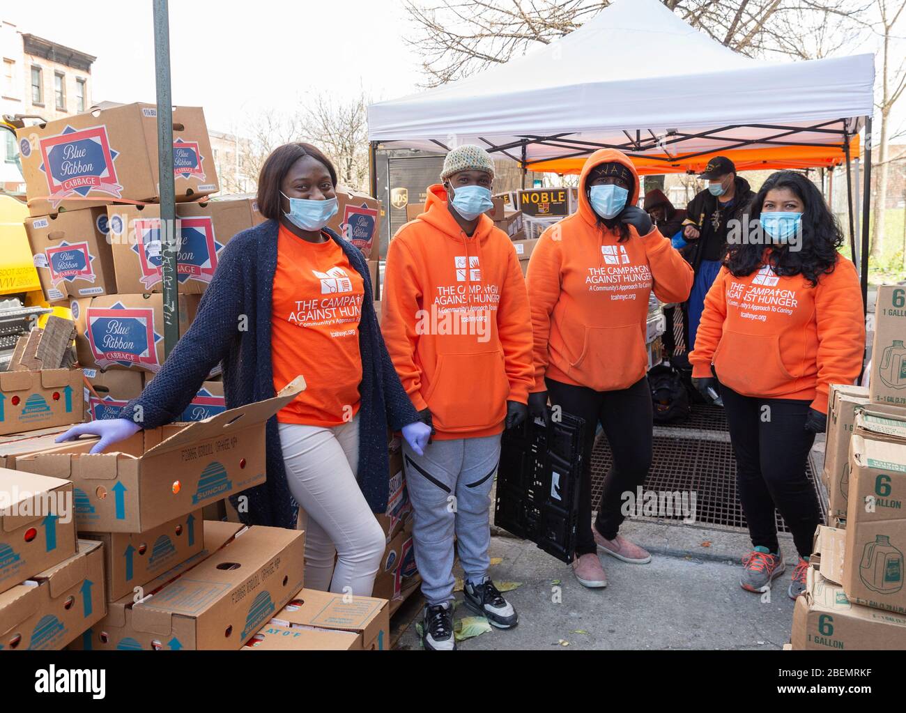 New York, NY - April 14, 2020: Workers pose during distribution at food ...