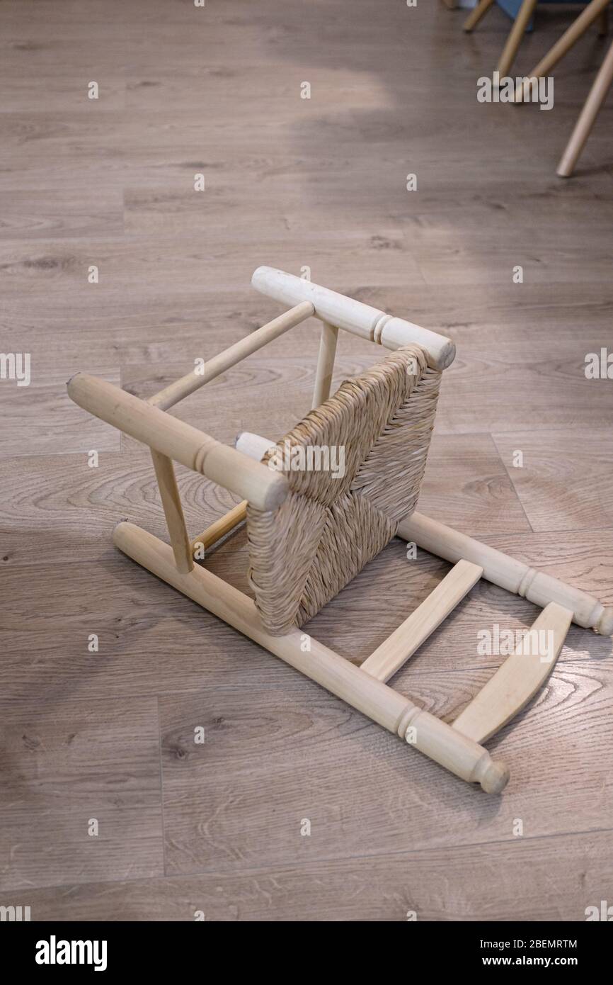 Wooden chair fallen on an interior hardwood floor Stock Photo - Alamy