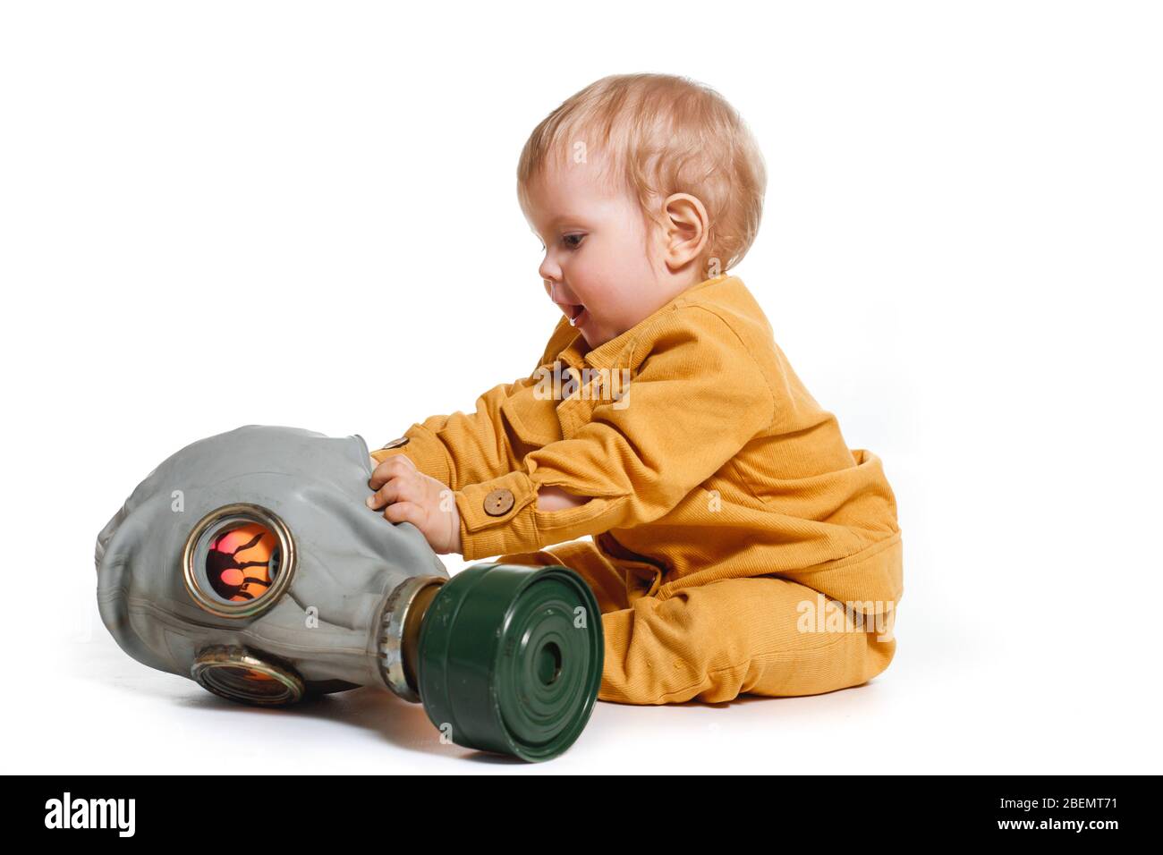 a small boy in a yellow suit with a gas mask, isolated on a white ...