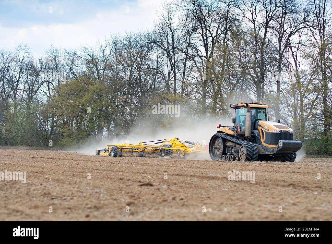 The tractor on the huge field, a farmer riding a tractor, a tractor ...