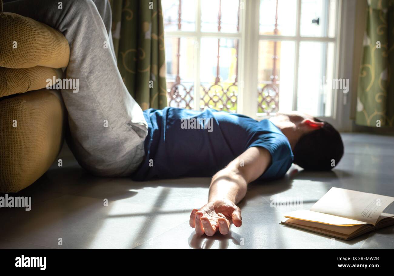 Bored young man at home looking through the window and wanting to get ...