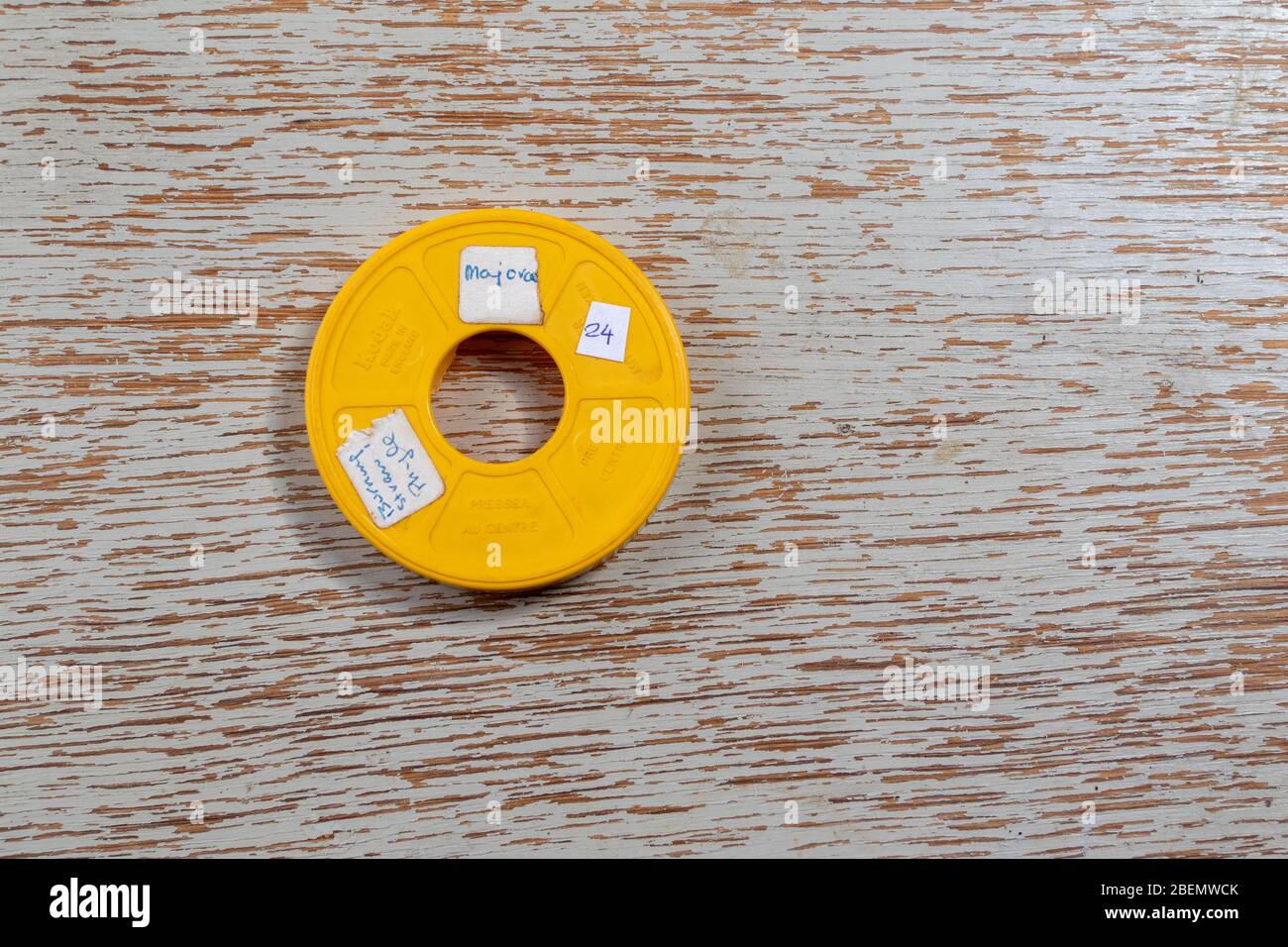 Yellow plastic cover for a 8mm spool of film Stock Photo - Alamy