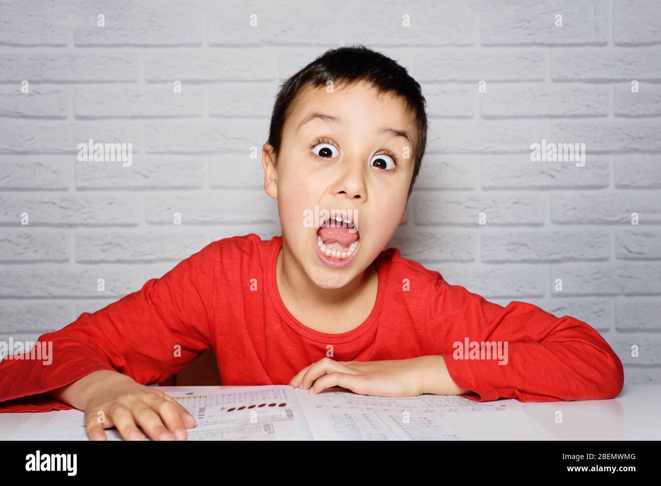 Upset boring schoolboy doing homework. Child tired of doing homework ...