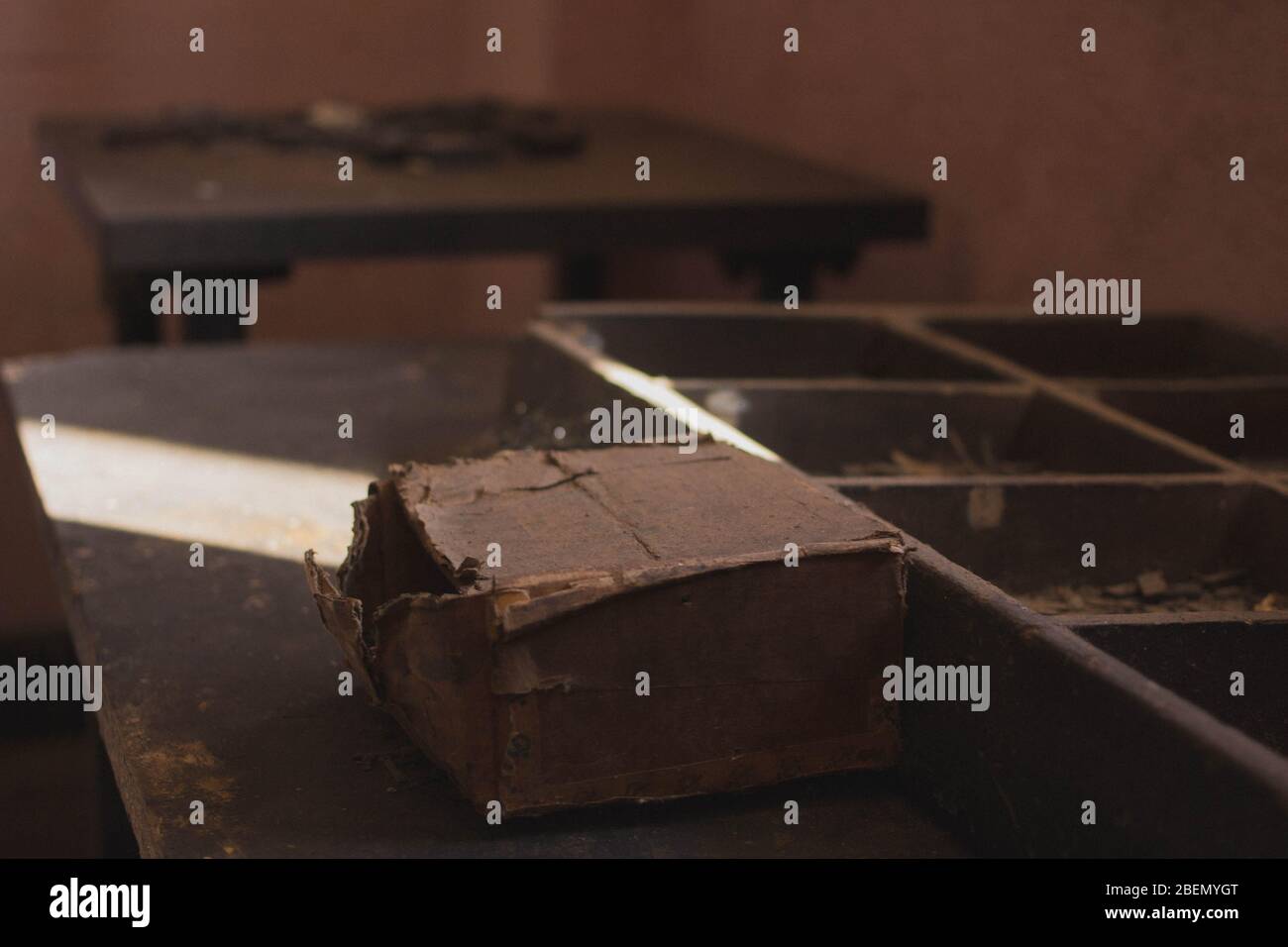 Dusty workbench in a dramatically lit workshop Stock Photo - Alamy