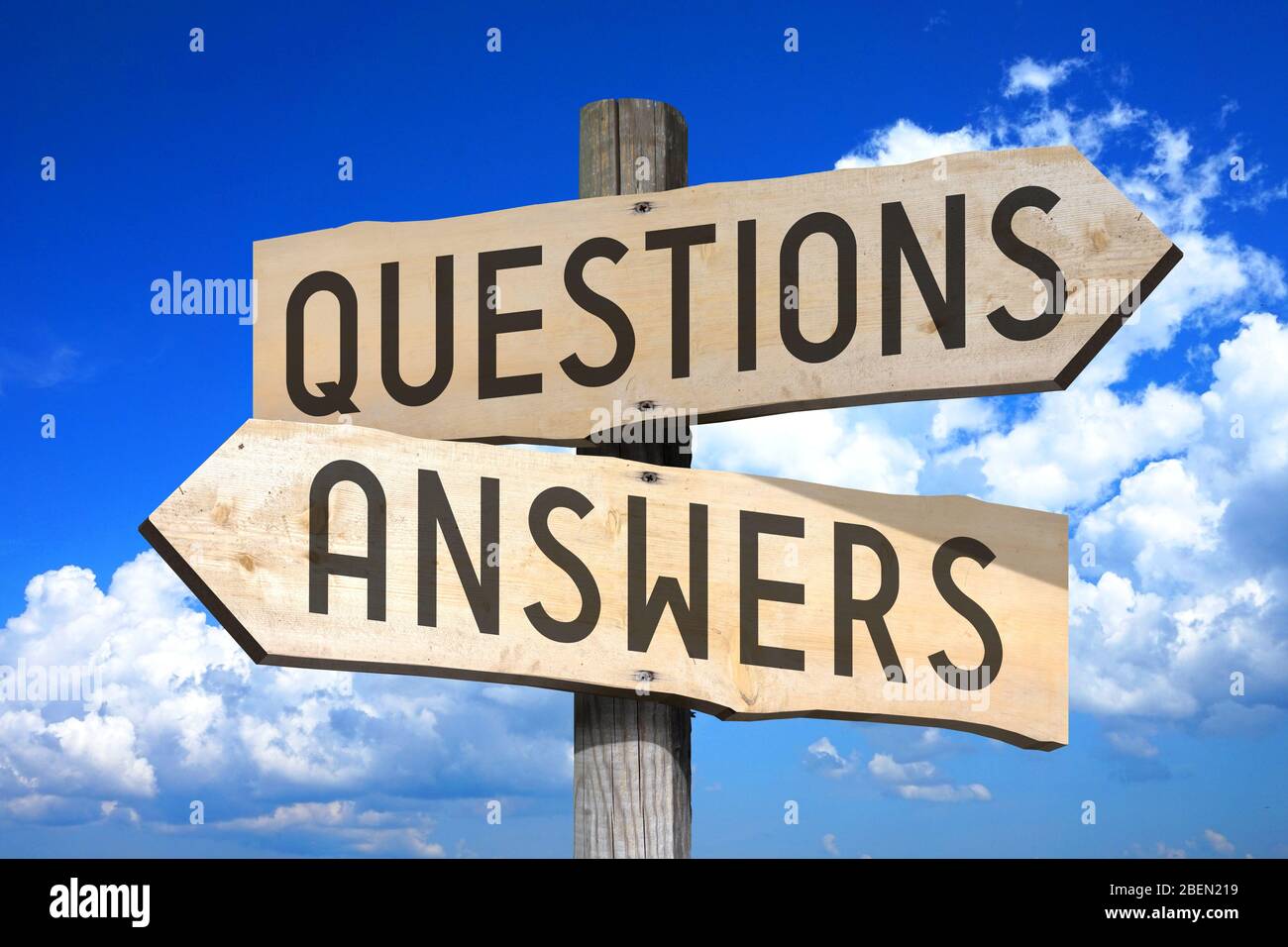 Wooden signpost with two arrows, sky Stock Photo - Alamy