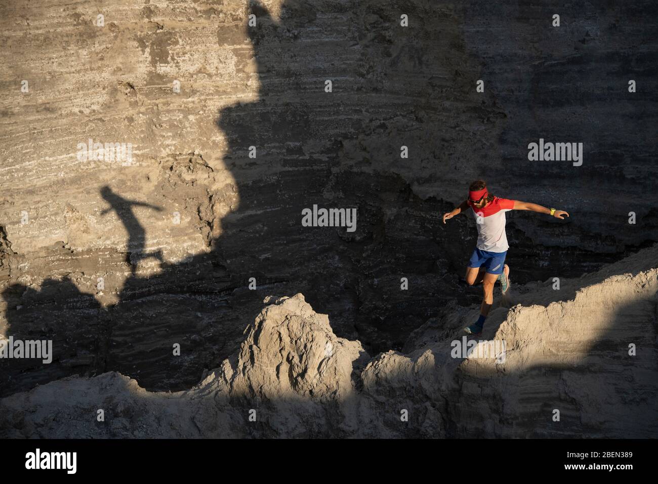 One man trail running down through a ridge on a sandy terrain Stock ...
