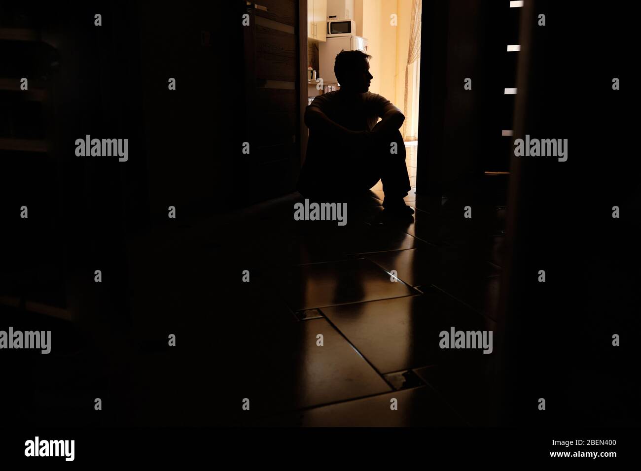 Man sitting alone in empty hi-res stock photography and images - Alamy