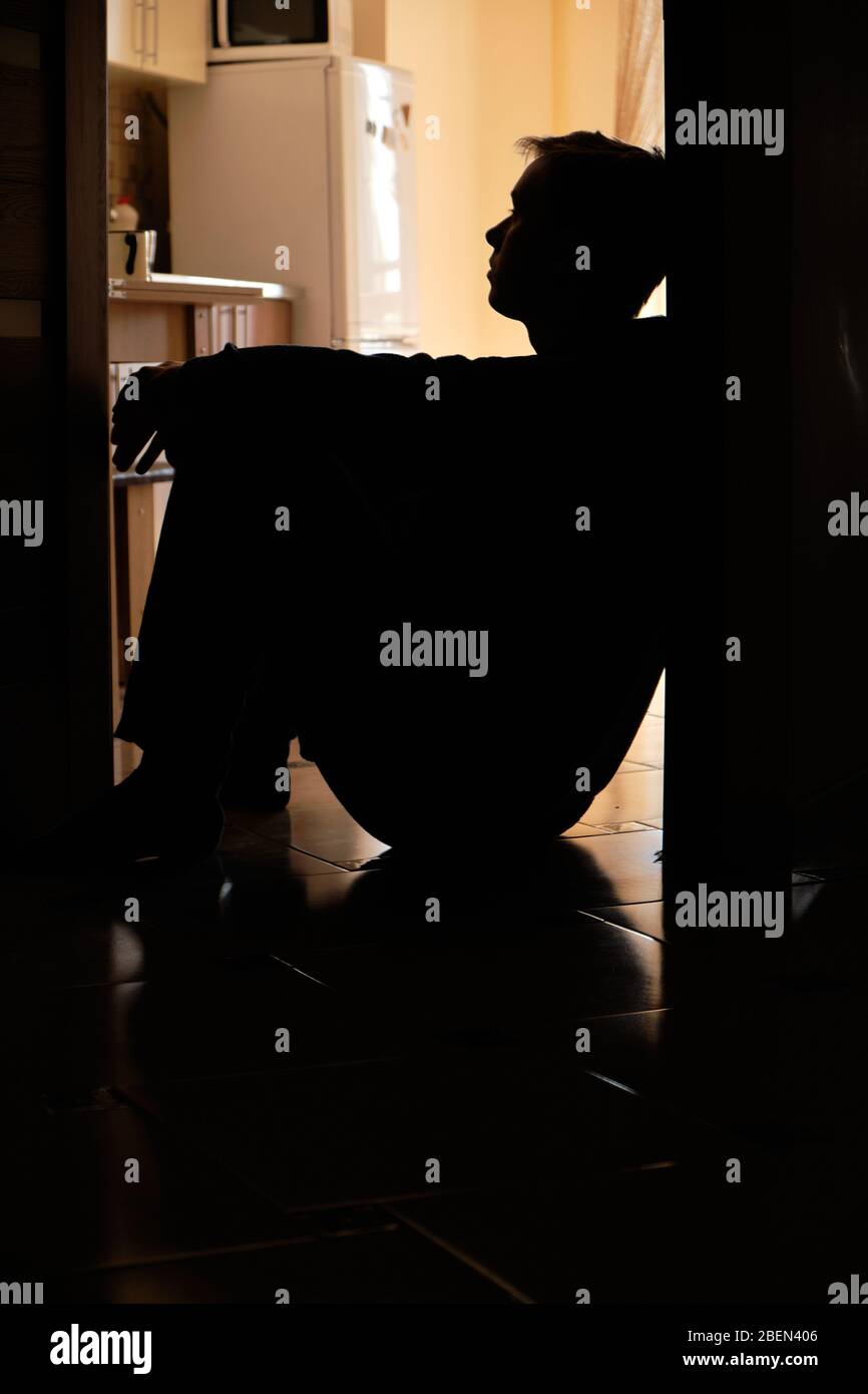 A man alone with himself in an empty apartment is experiencing lonelin ...