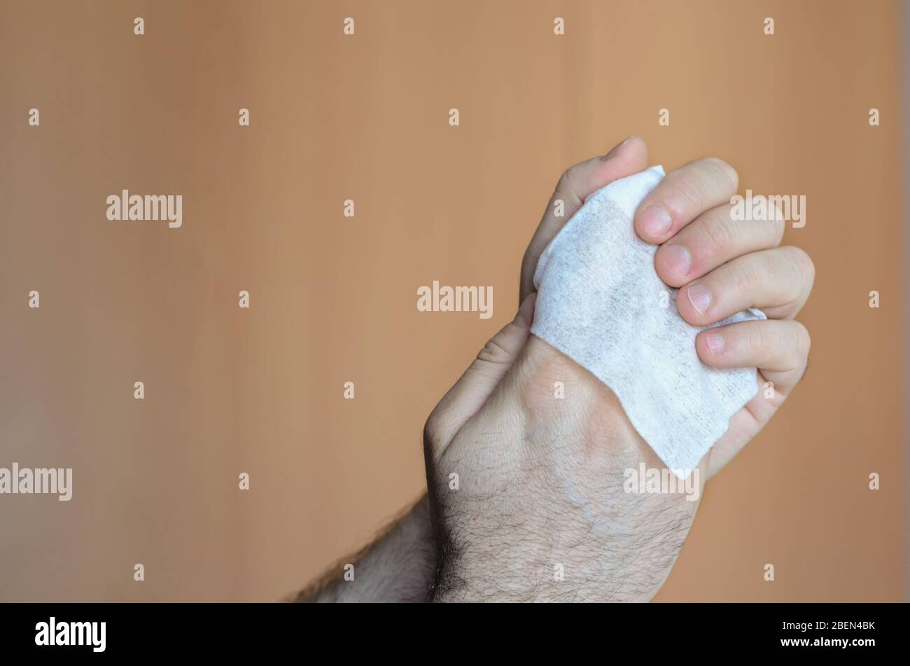 Man cleaning his hands with antibacterial sanitary napkin after working ...
