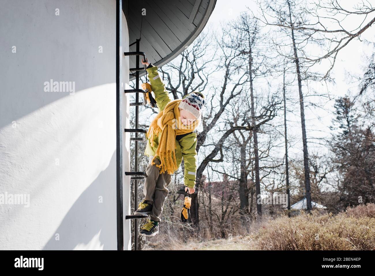 young boy climbing a water tower in winter Stock Photo - Alamy
