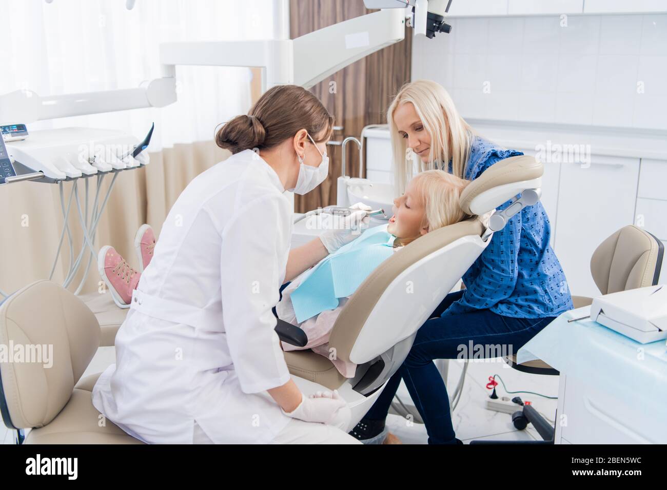 A child having a dental checkup with her mother Stock Photo - Alamy